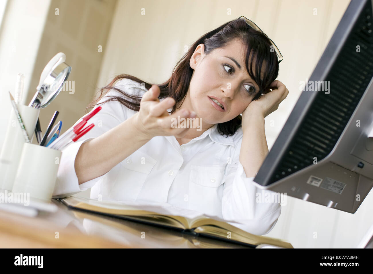 Frustrated woman using computer Stock Photo - Alamy