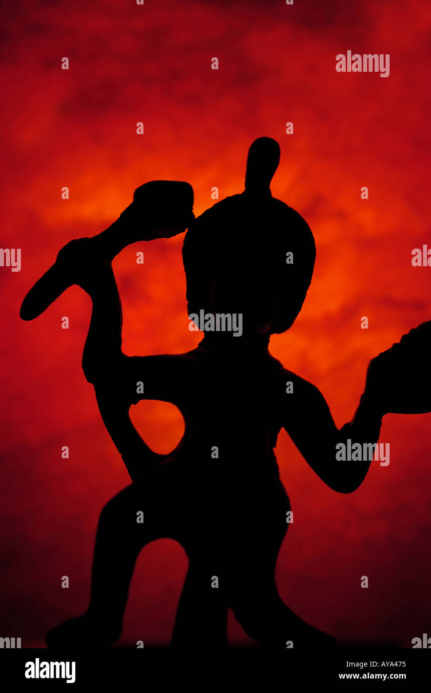 Hindu God against an orange lit background Stock Photo - Alamy