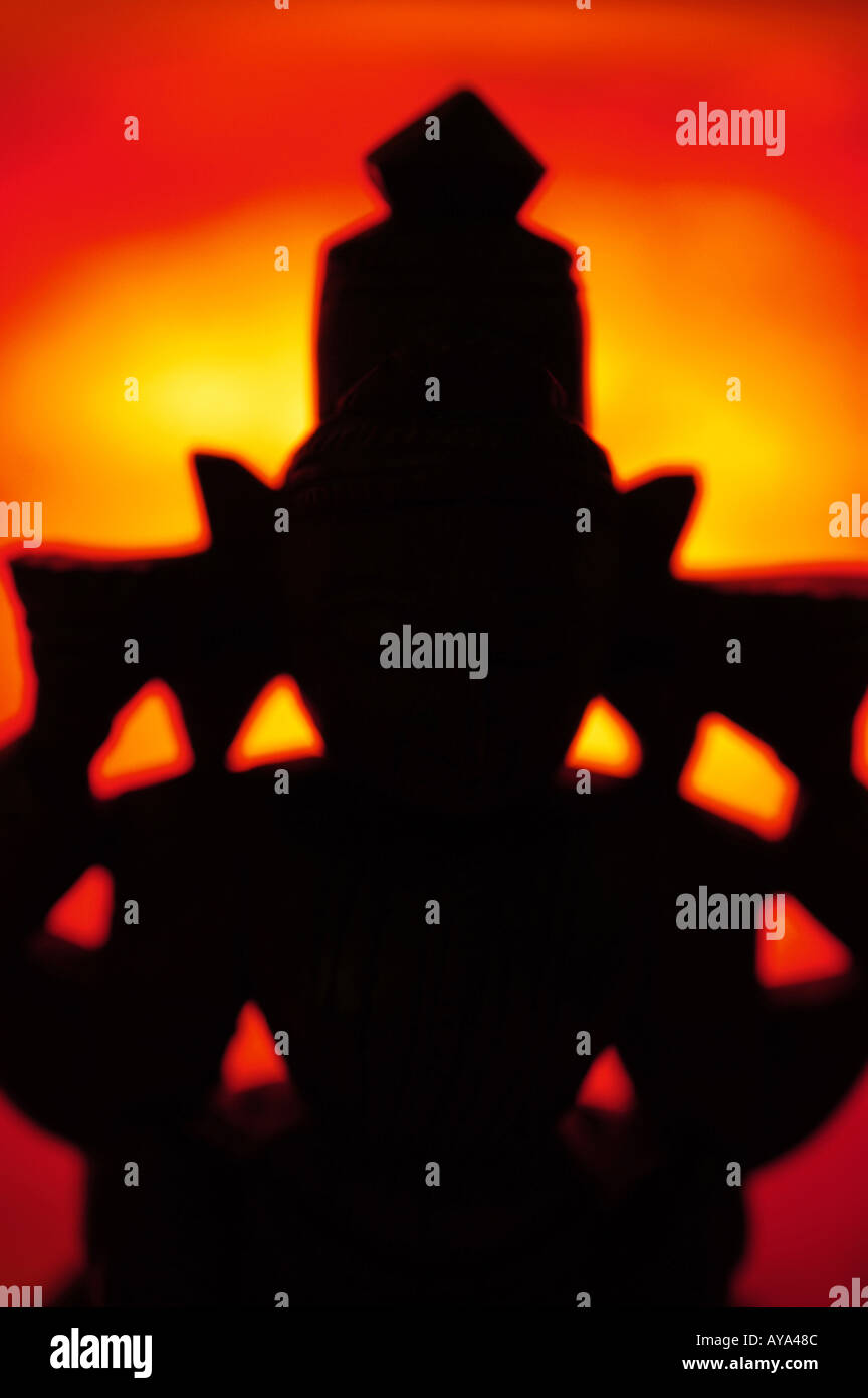 Hindu God against an orange lit background Stock Photo - Alamy