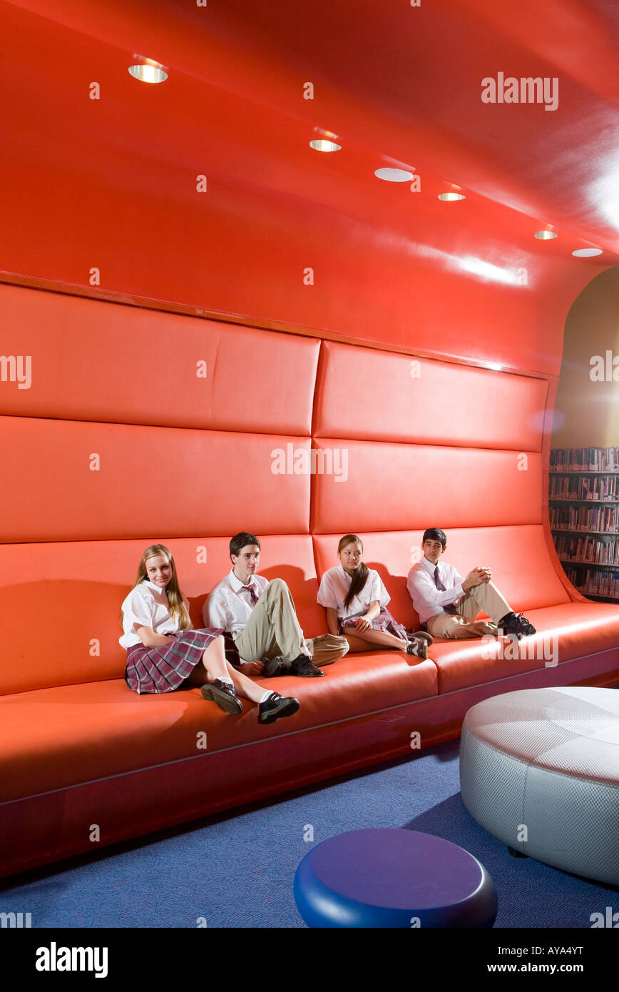 Group of teenage students hanging out in lounge area of library Stock ...