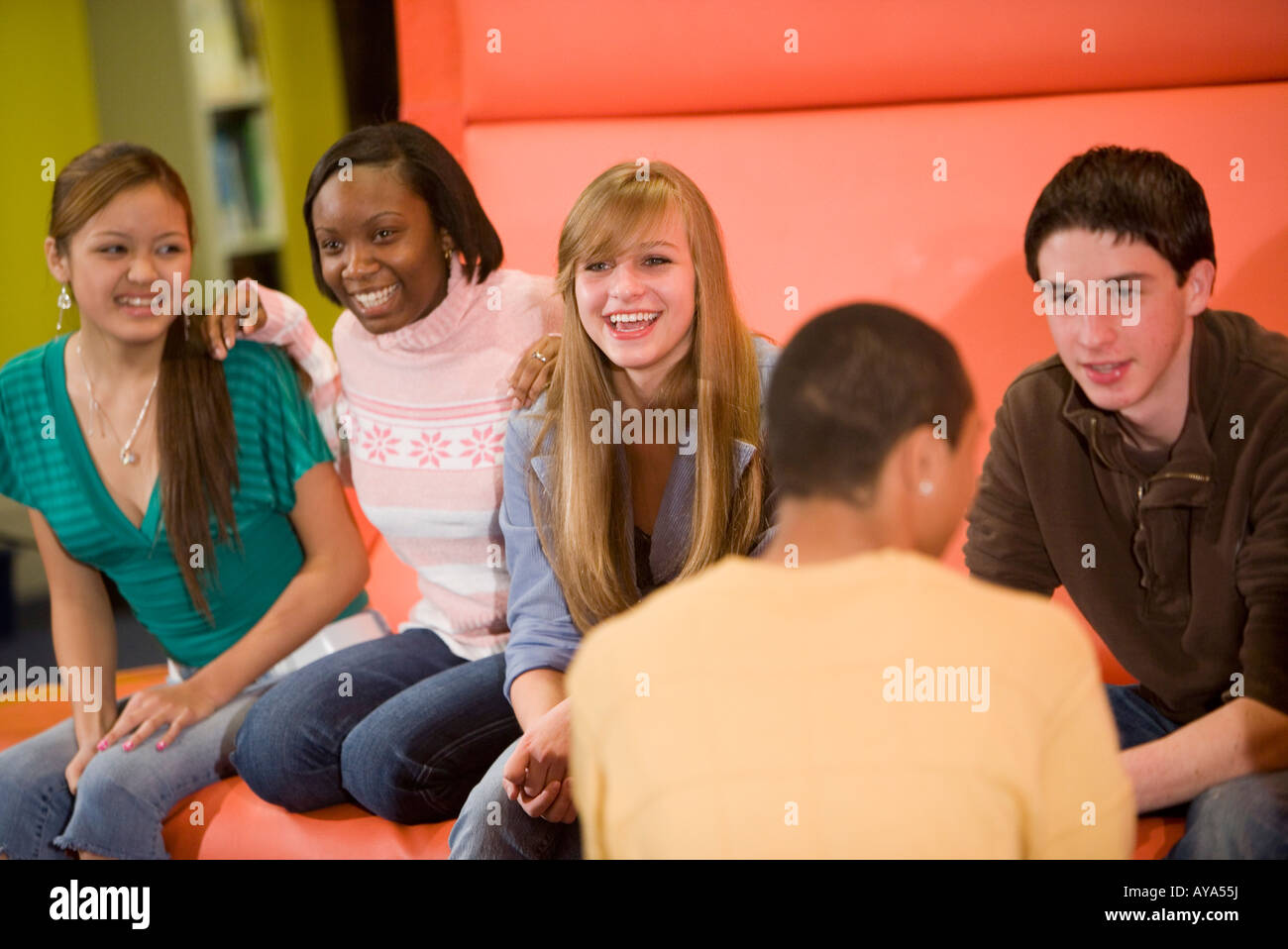 Teenage boys and girls sitting together and socializing Stock Photo - Alamy