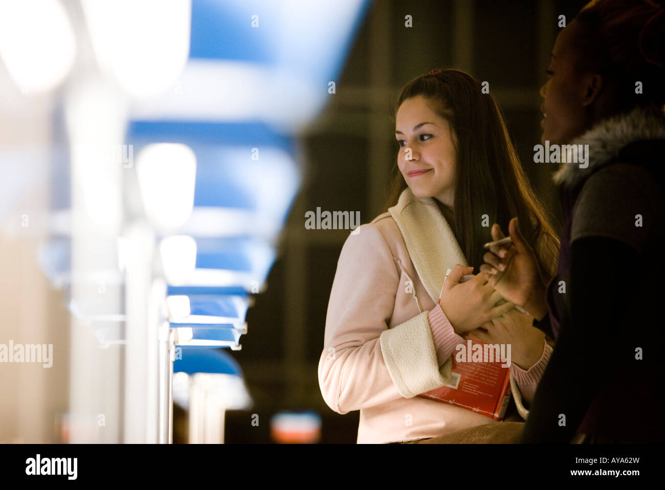 Two young women sitting in the reading room of a library Stock Photo ...