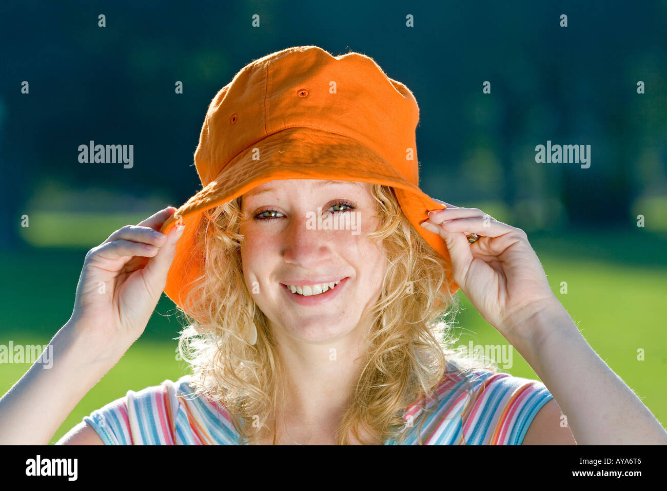 A laughing young woman with a slouch hat Stock Photo - Alamy