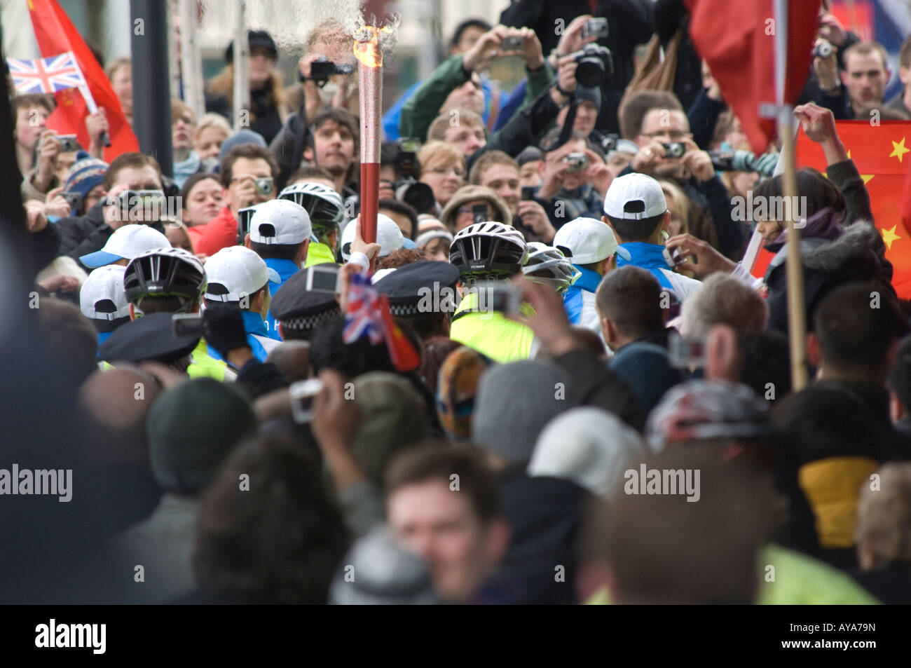 Crowds surround the Olympic Torch during the relay through London on ...