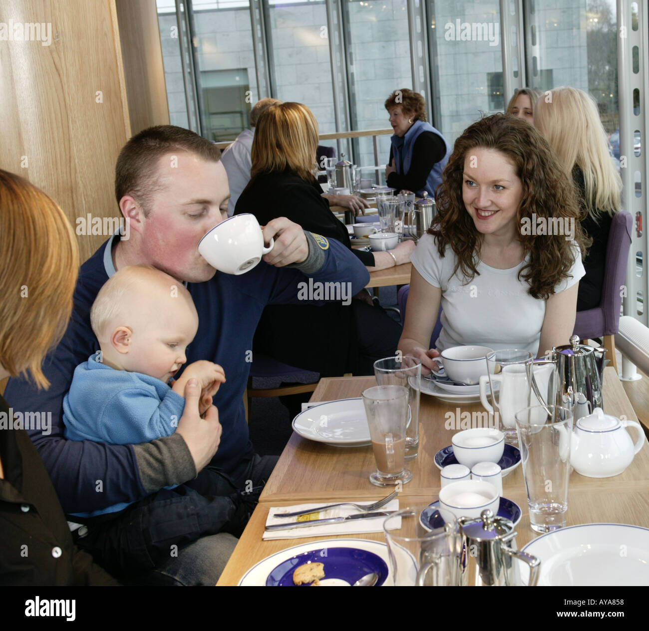 Diners eating in restaurant with infant Stock Photo - Alamy