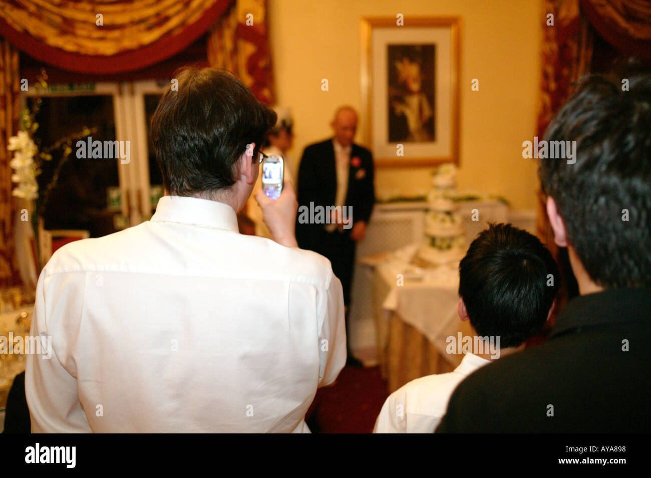Wedding guest taking a photo with a camera phone Stock Photo - Alamy