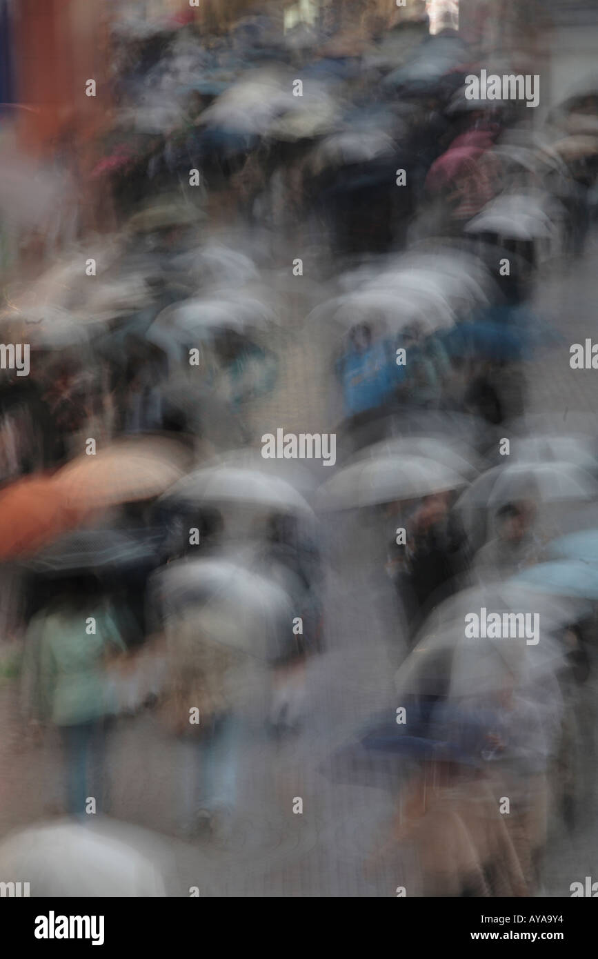 Asia Tokyo Japan Blurred image of shoppers with umbrella walking down ...