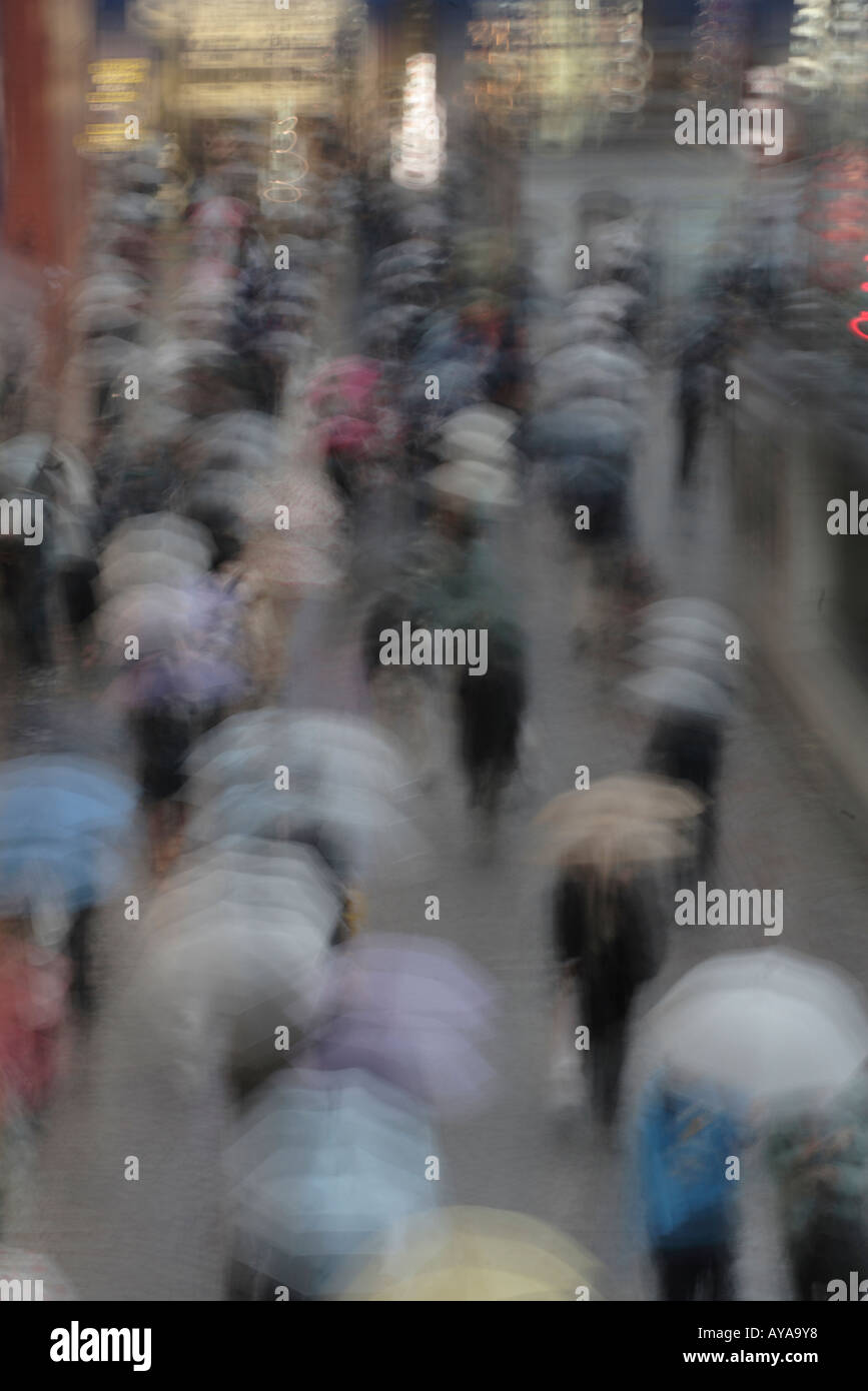 Asia Tokyo Japan Blurred image of shoppers with umbrella walking down ...