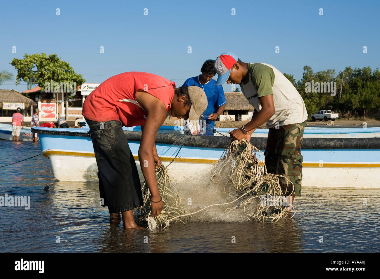 Fishermen straightening fishing nets Las Penitas Pacific Coast of ...