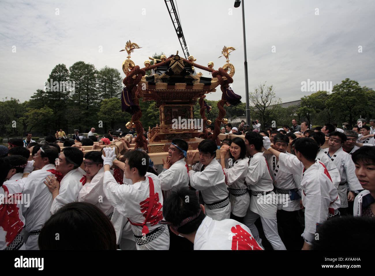 Asia Tokyo Japan Procession carries Shinto shrine down street toward ...