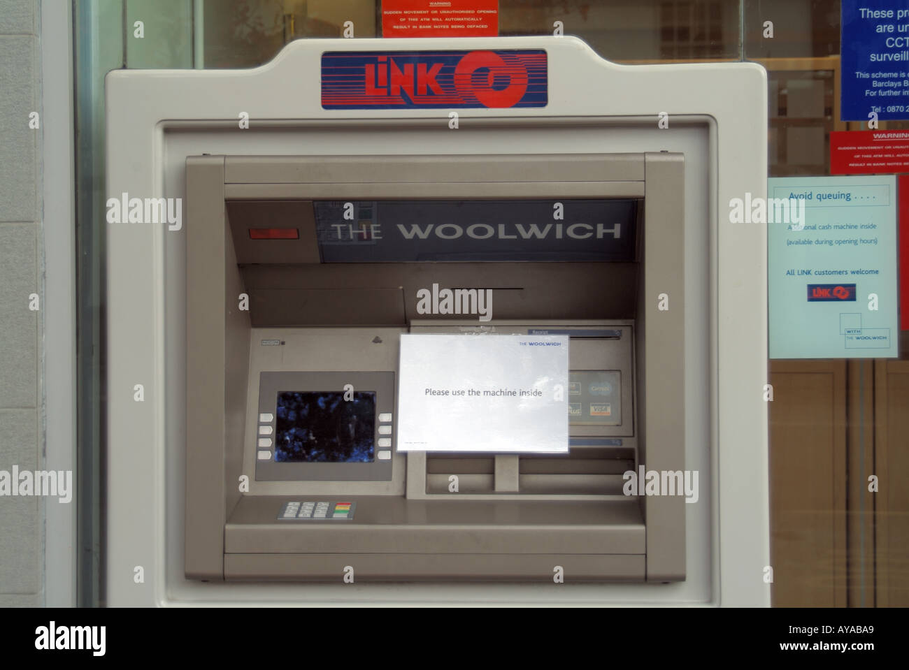 Woolwich Bank automated cash machine with notice implying that it is ...