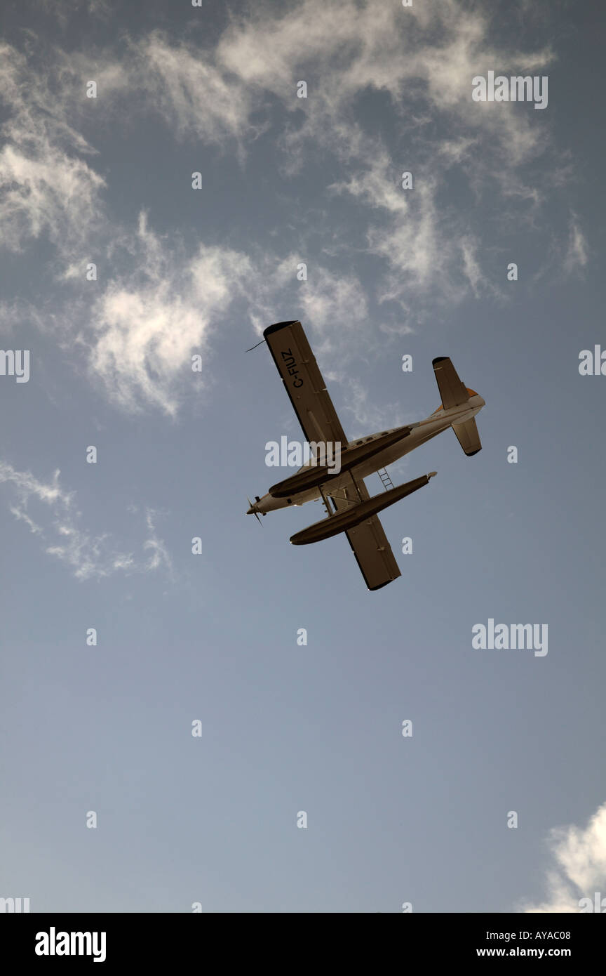Float plane and cirrus clouds in blue sky Stock Photo - Alamy