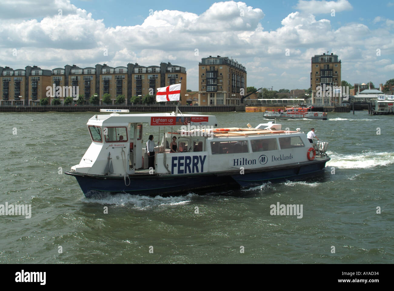 East London River Thames small ferry running between Hilton hotel on ...