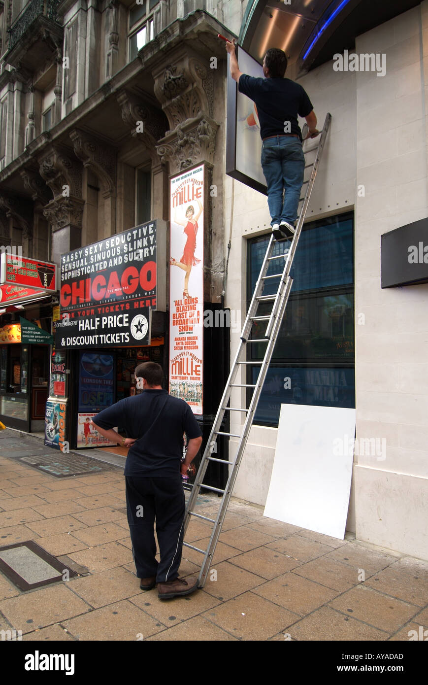 Man footing ladder hi-res stock photography and images - Alamy