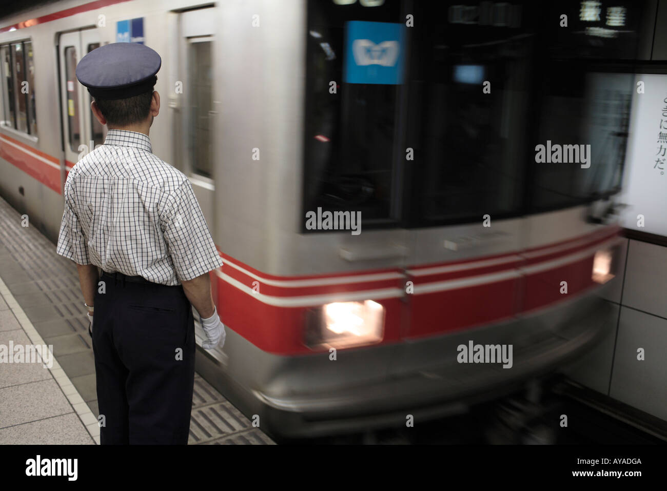 Asia Tokyo Japan Platform guard and subway train during morning rush ...
