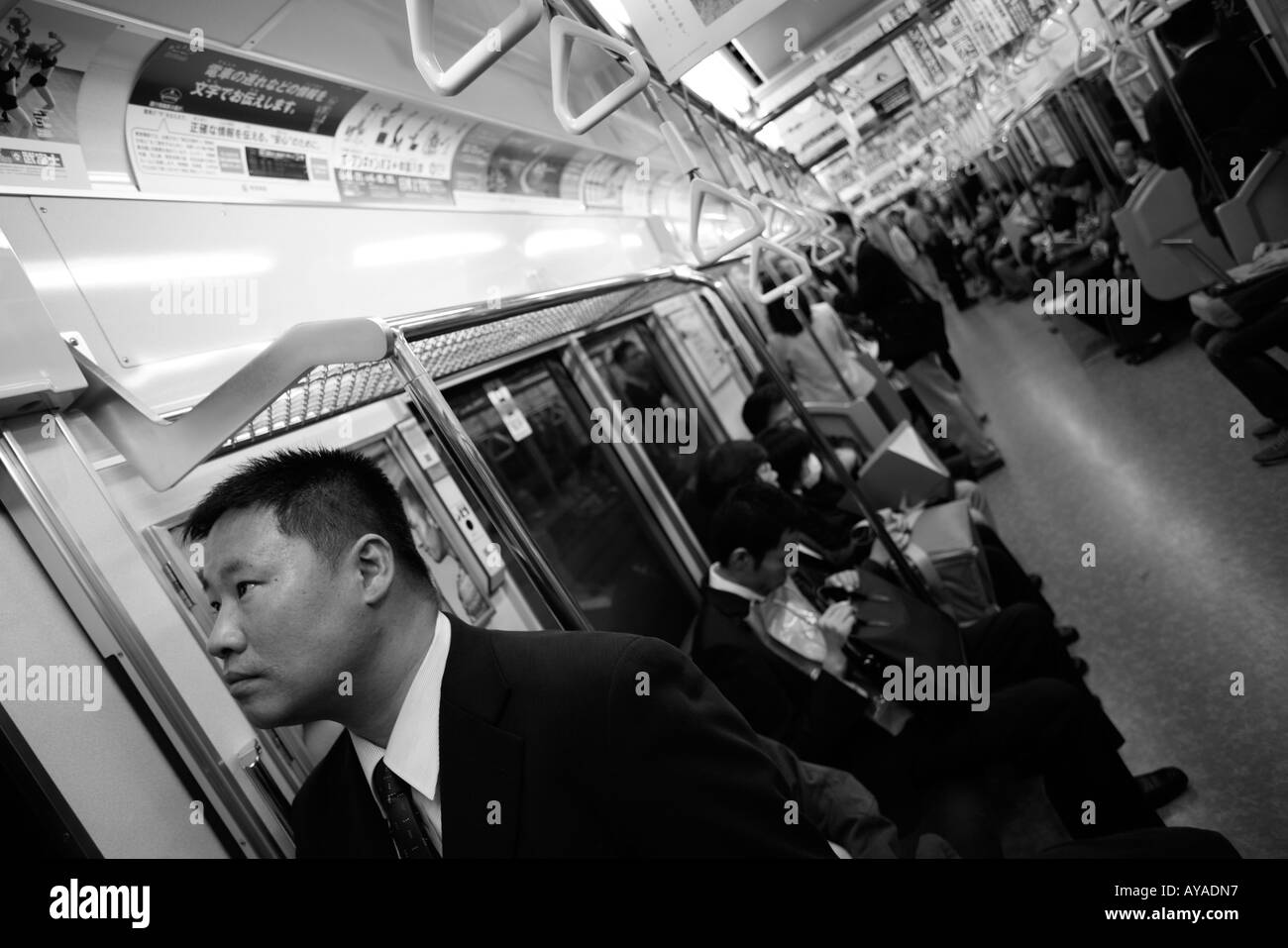 Asia Tokyo Japan Young man in business suit aboard subway train Stock ...