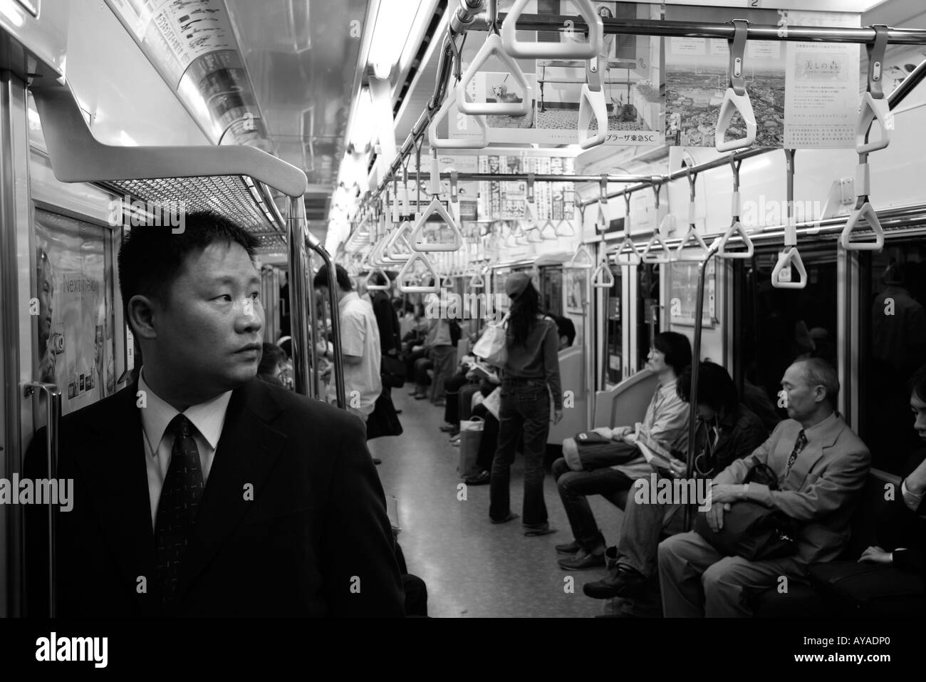 Asia Tokyo Japan Young man in business suit aboard subway train Stock ...