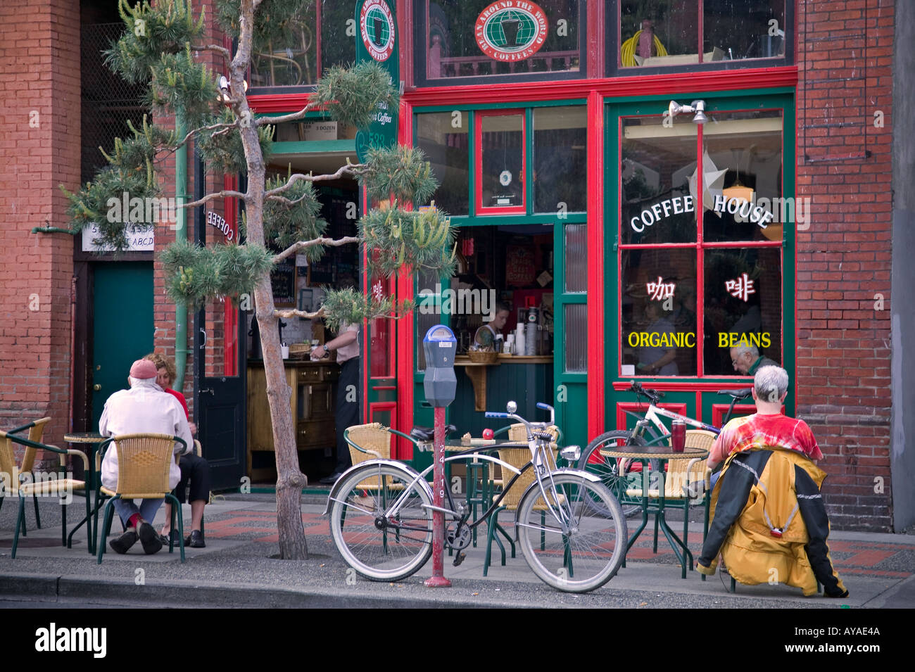 people at sidewalk tables outside coffee house in Chinatown area of ...