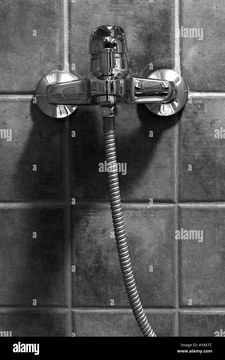 Bathroom Tap With Shower Pipe Mounted on a Tiled Wall Stock Photo - Alamy
