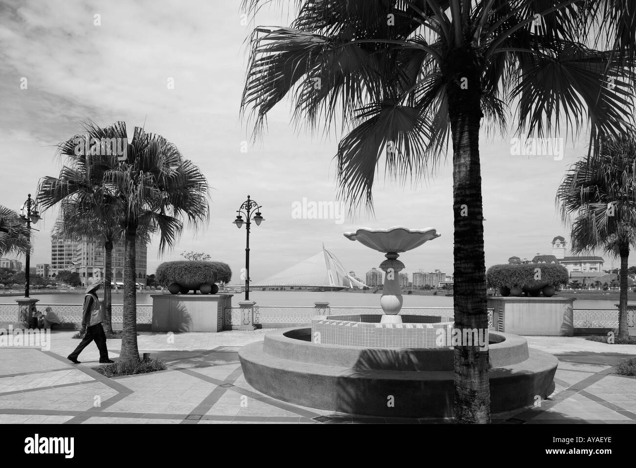 Malaysia Kuala Lumpur Palm trees and gardens along artificial lake ...