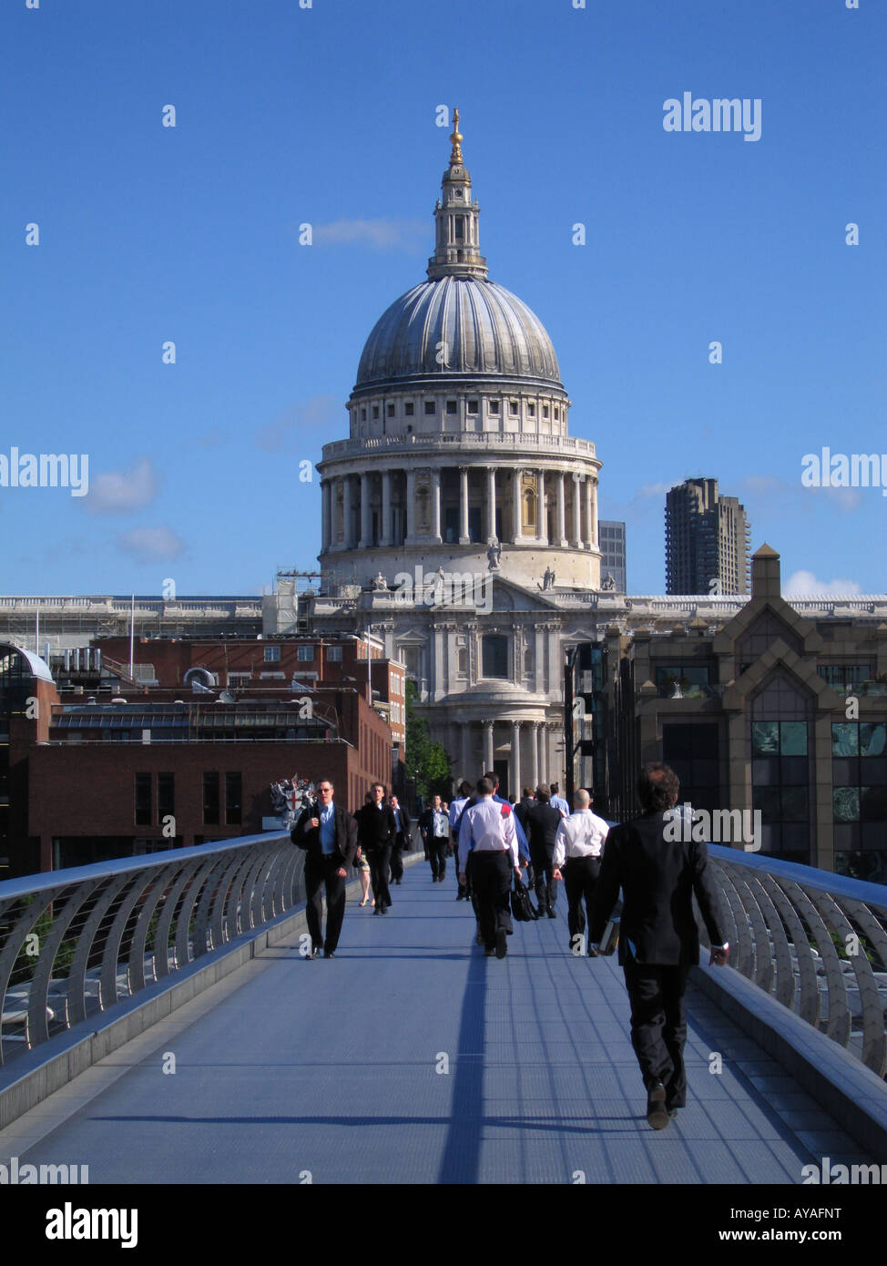 Commuters walking over the London Millennium Bridge with St Paul s ...