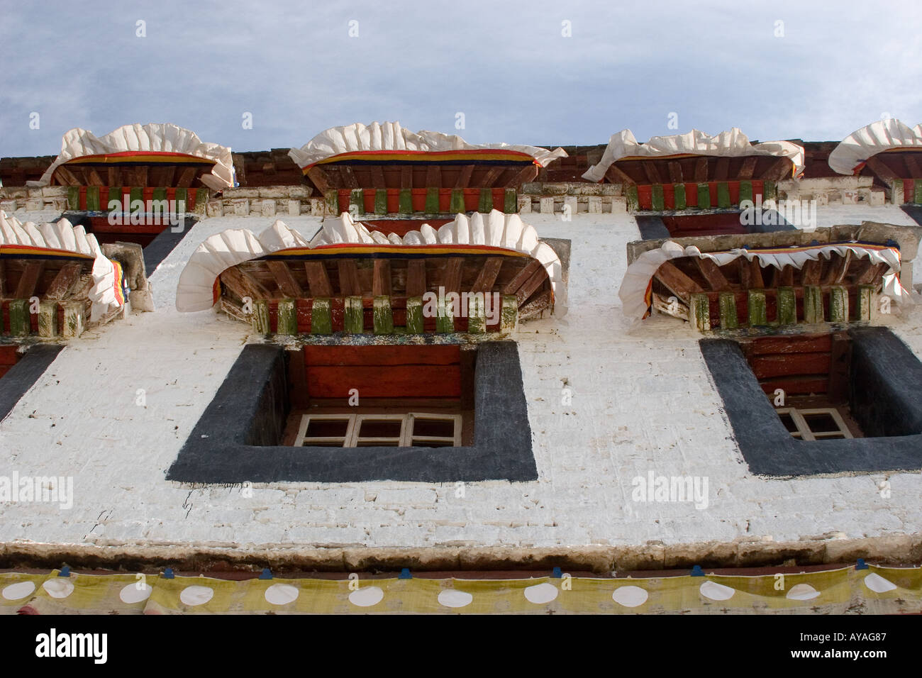 Looking up at colorfully curtained windows at the Potala Palace in ...