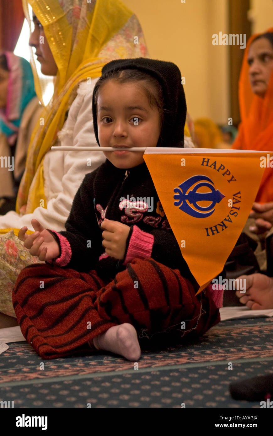 Young Sikh child inside temple or Gurdwara on the festival of Vaisakhi ...