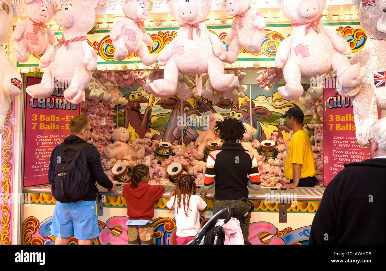 Man woman and children playing a seaside arcade fair type of game on ...