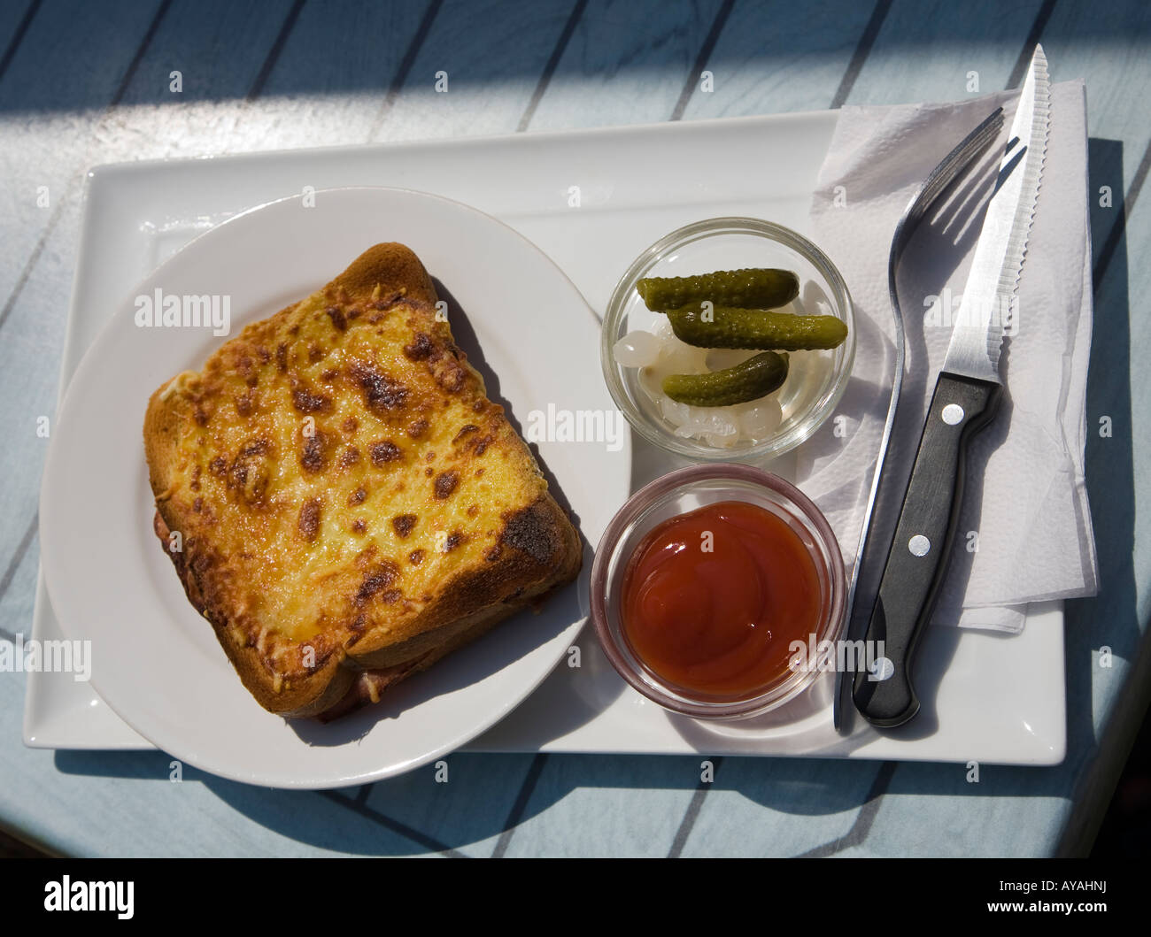 Traditional meal croque monsieur toasted ham and cheese with pickled ...