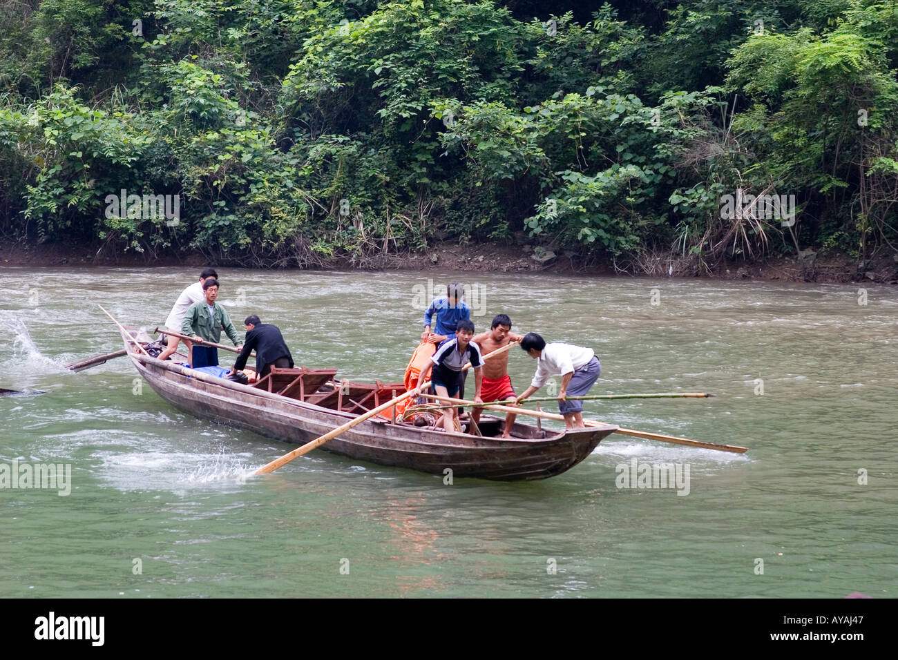 Chinese peapod boat fishermen rowing up a tributary of the Yangtze ...