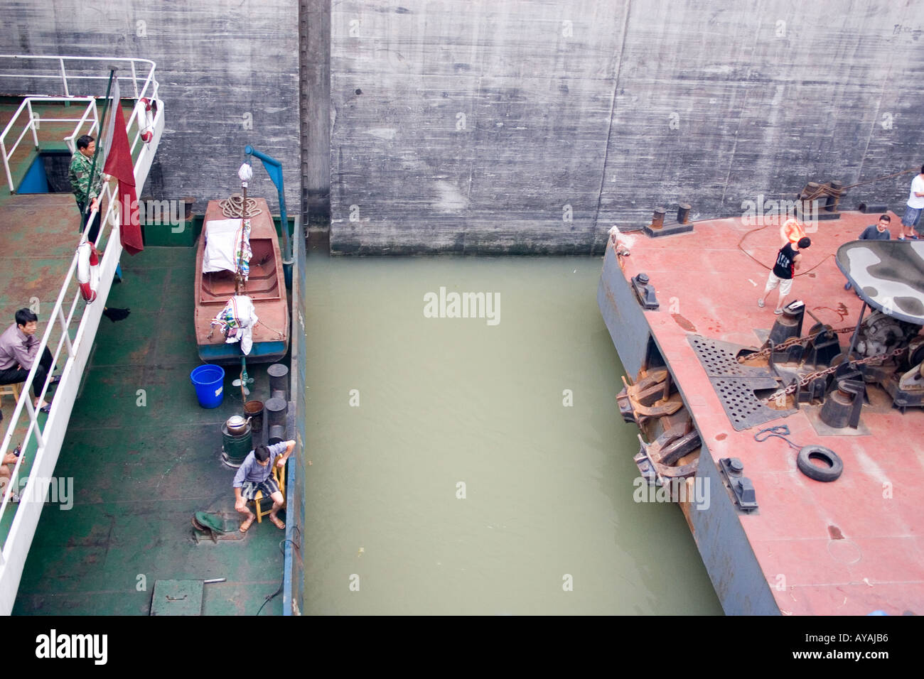 Barges and sailors waiting in a ship lock on the Yangtze River in China ...