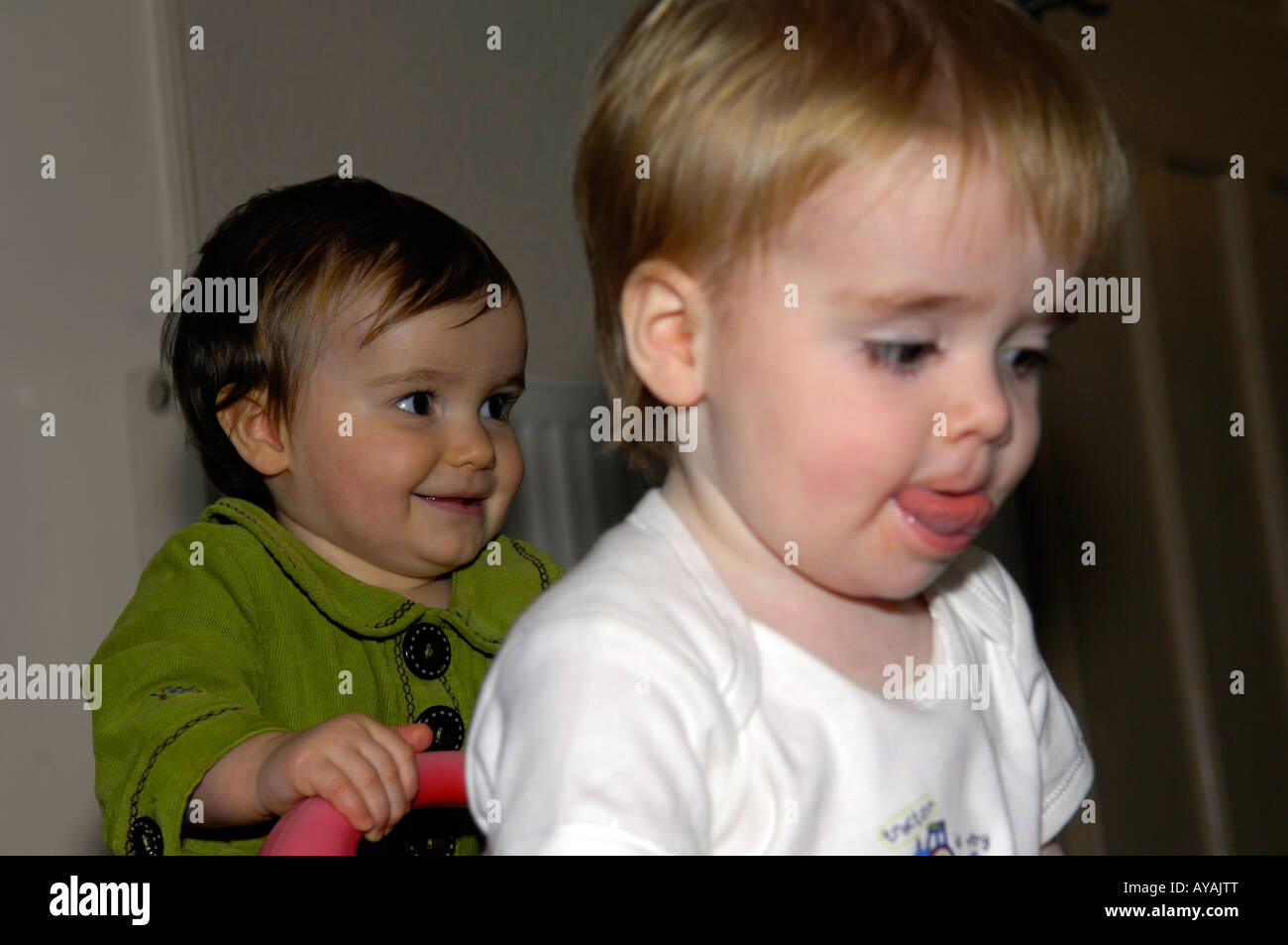 cousins boy girl toddlers one and two year old babies fun play together family Stock Photo - Alamy
