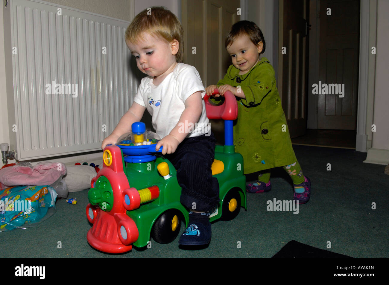 cousins boy girl toddlers one and two year old babies fun play together family Stock Photo - Alamy