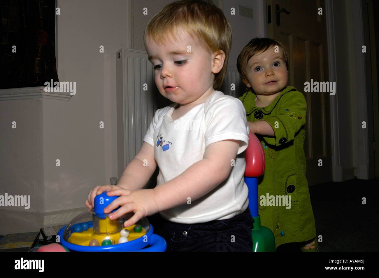 cousins boy girl toddlers one and two year old babies fun play together family Stock Photo - Alamy