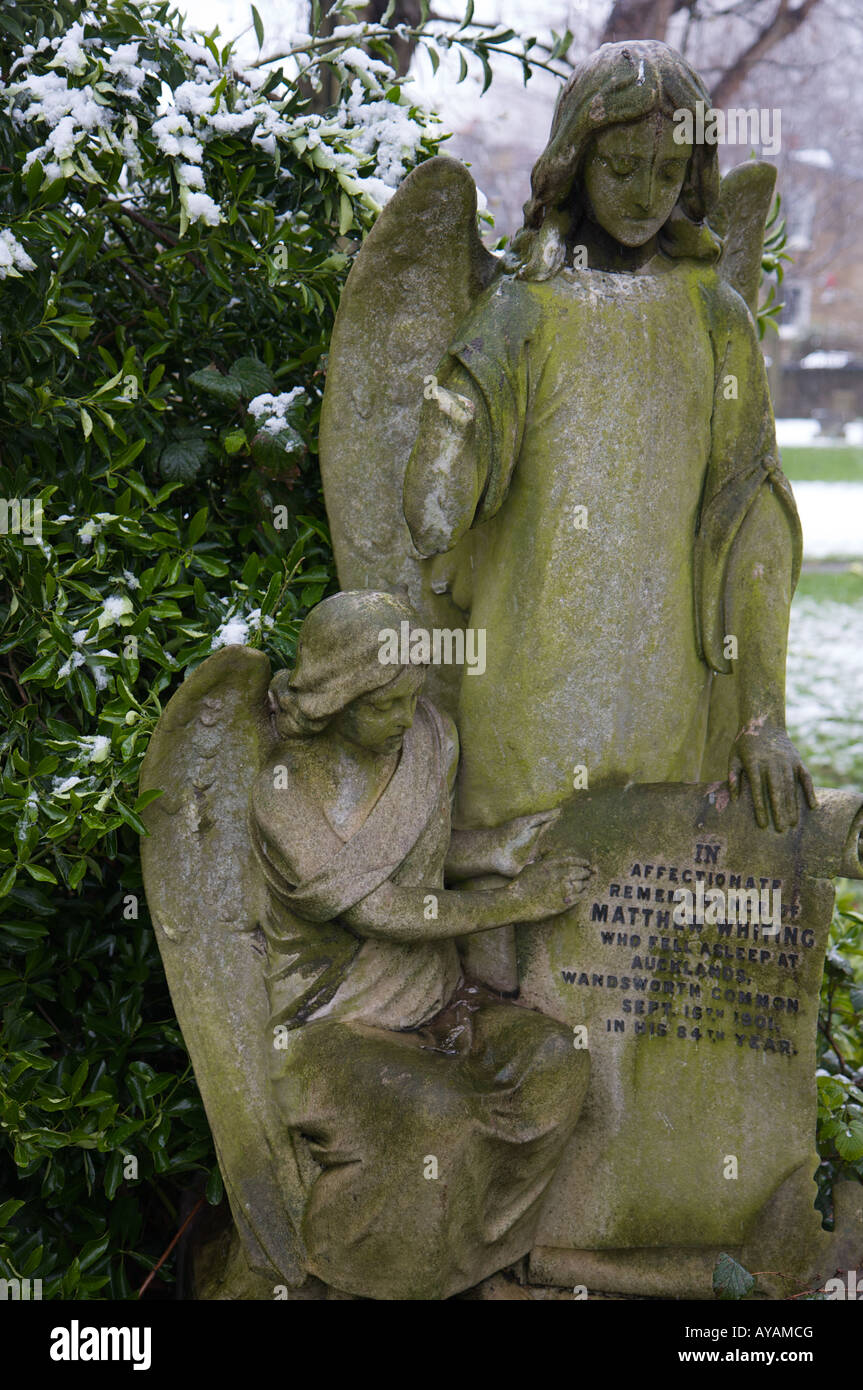A Statue of Two Angels Holding a Scroll During Snowfall in St Mary's ...