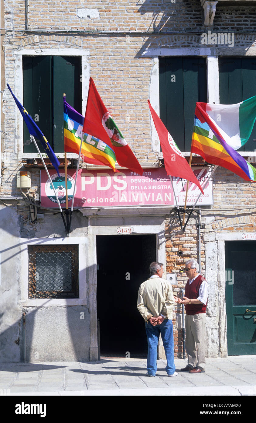 Communist party office exterior on May Day flags two men outside red ...