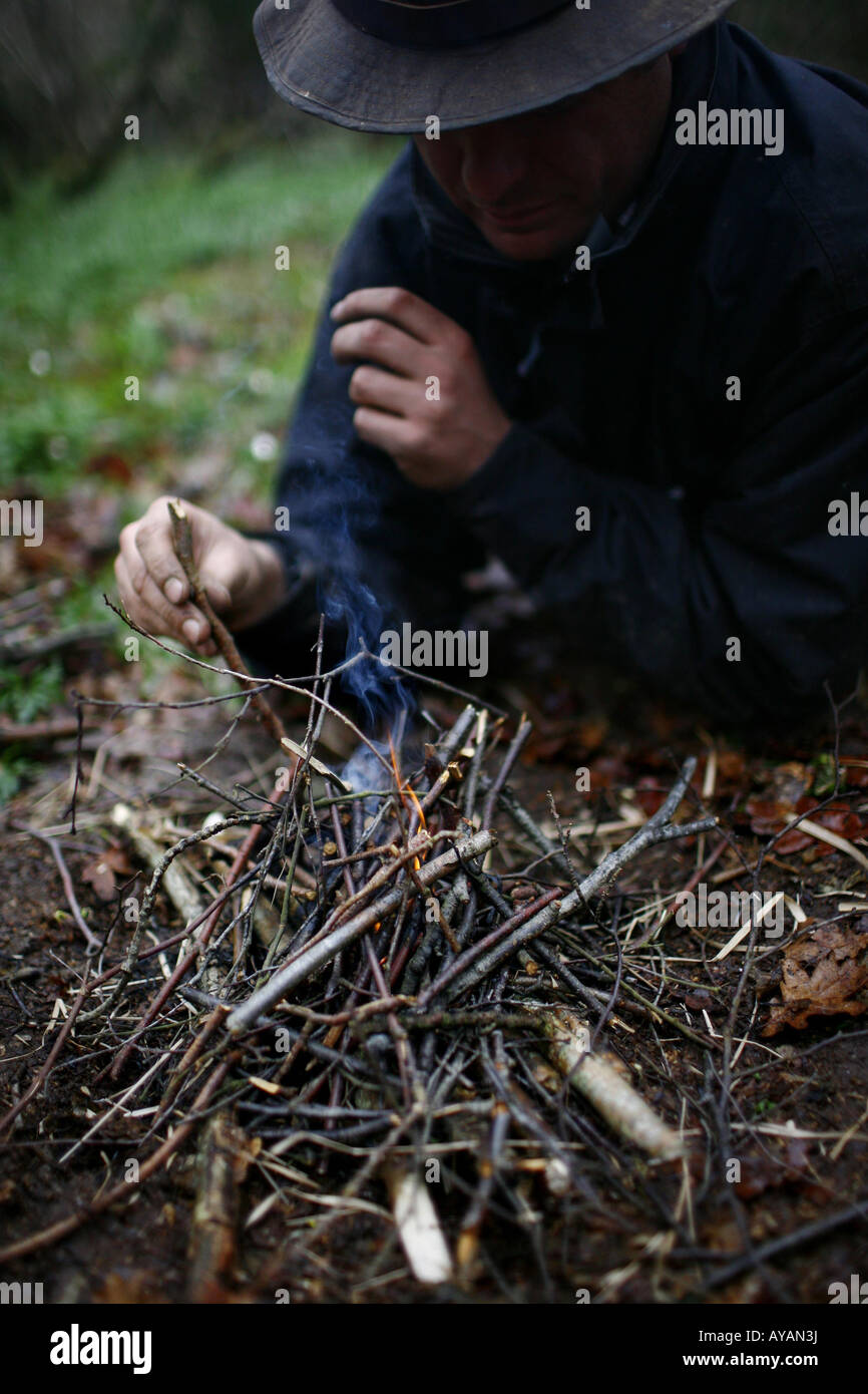 A man makes fire during a bushcraft course Stock Photo - Alamy