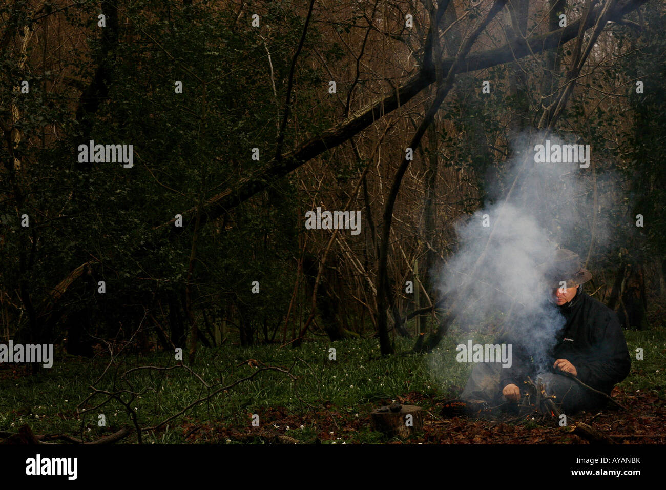 A man makes fire during a bushcraft course Stock Photo - Alamy