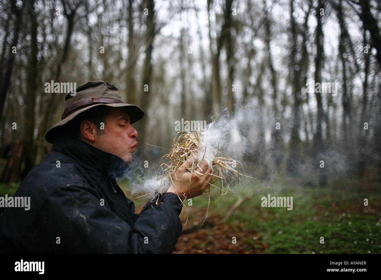 A man makes fire during a bushcraft course Stock Photo - Alamy