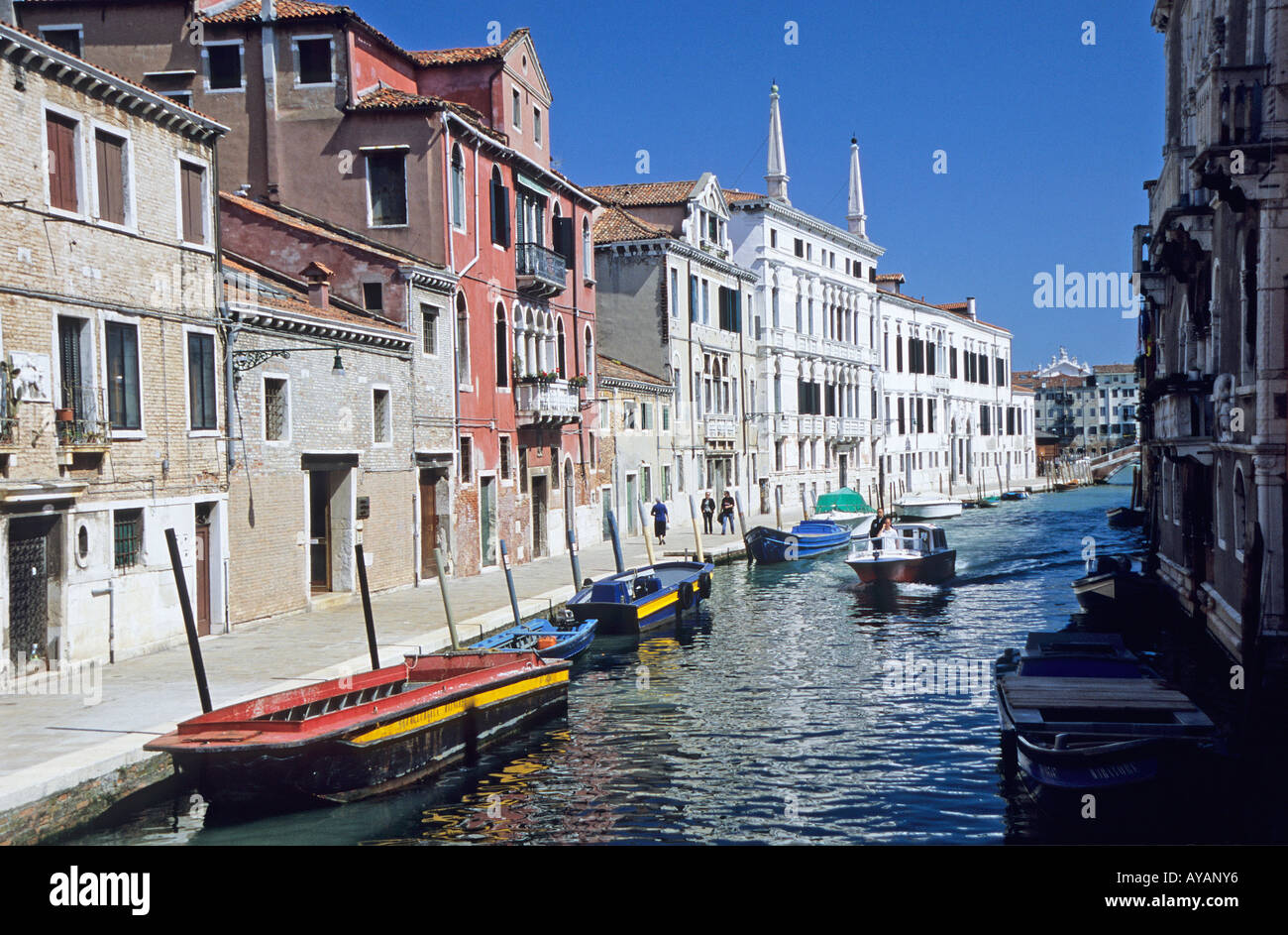 Canal side view near Campo dei Mori boats and buildings colourful blue ...