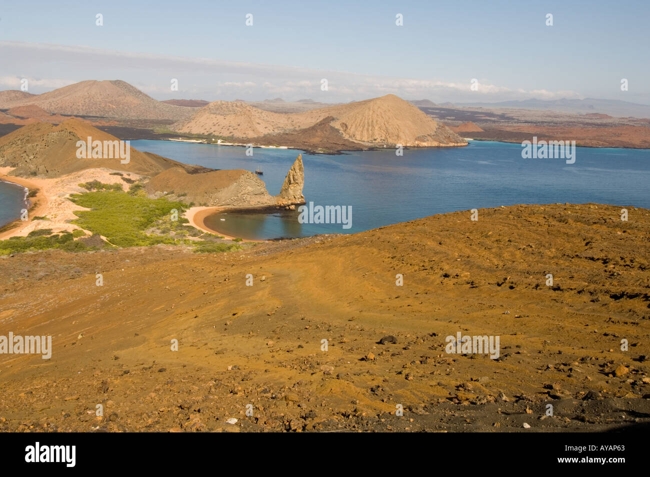 Pinnacle rock, volcanic cones and beach Isla Bartolome Galapagos ...