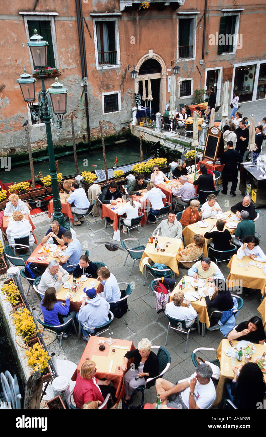 Canal side dining exterior tables many people canal and building in ...