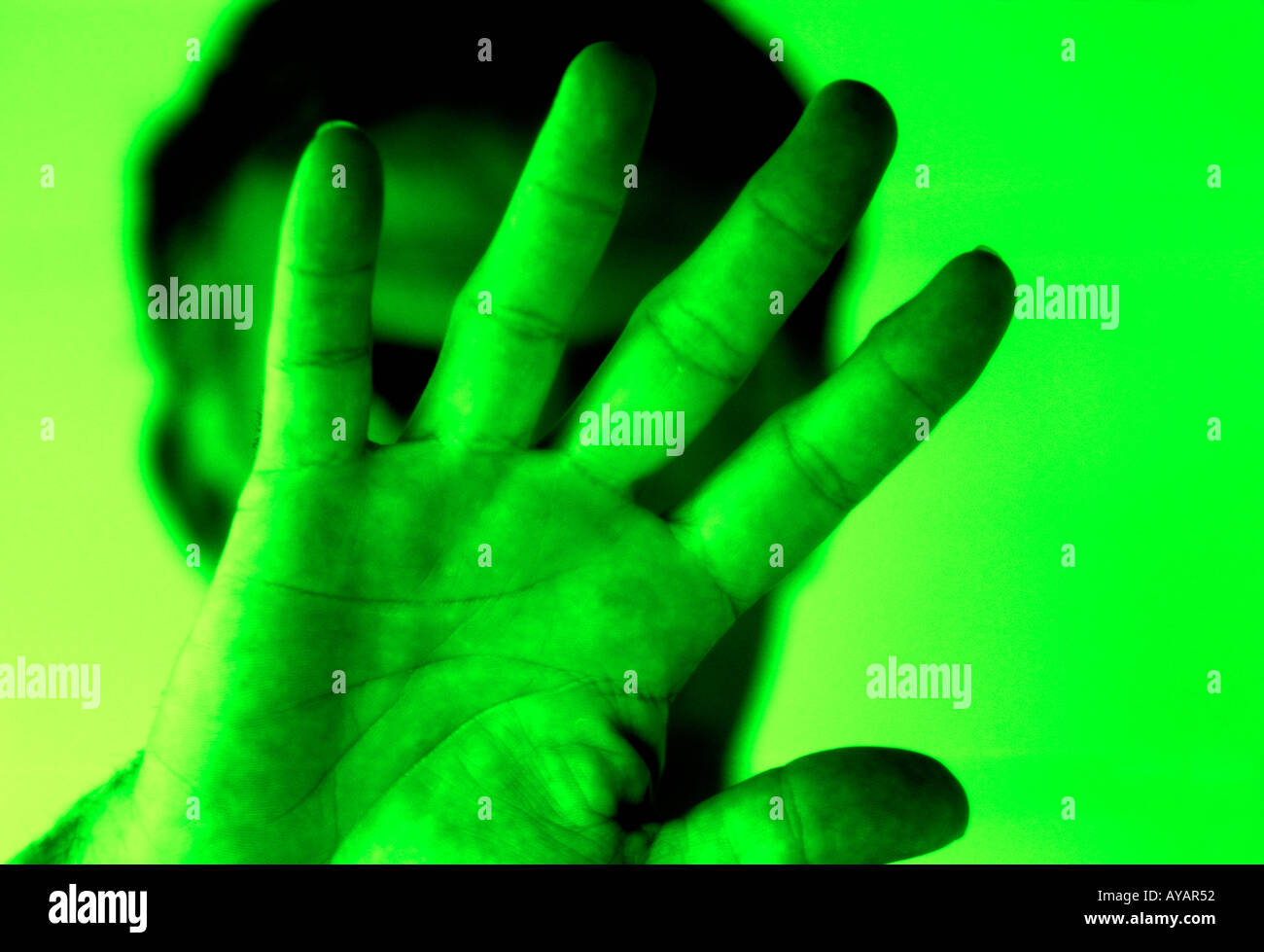 abstract view of male suspect shielding face with hand Stock Photo - Alamy