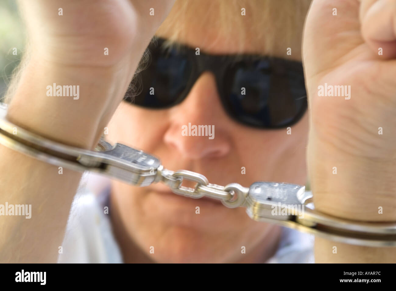 arrested man displaying handcuffs Stock Photo - Alamy
