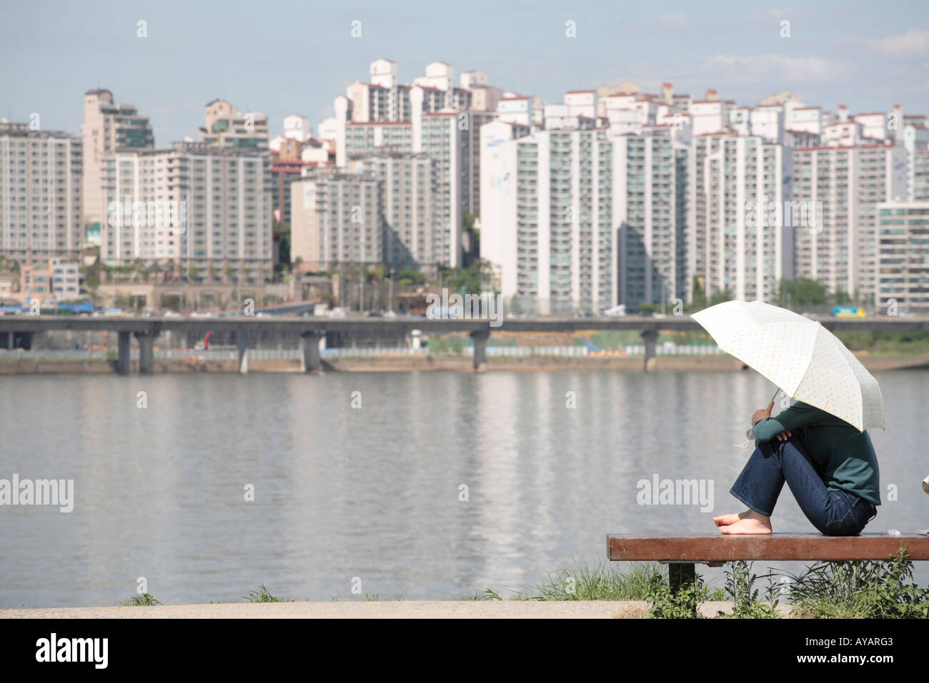 South Korea Seoul Woman sitting on bench along Hangang River Park Stock ...