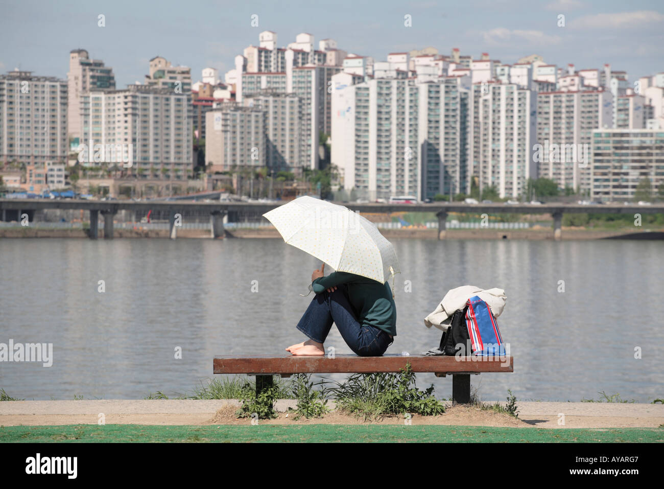 South Korea Seoul Woman sitting on bench along Hangang River Park Stock ...
