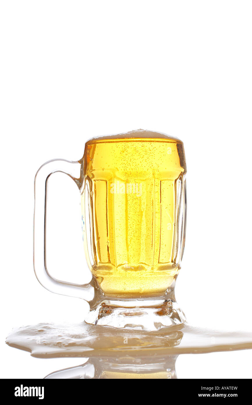 A mug of beer overflowing reflected on white background Stock Photo - Alamy