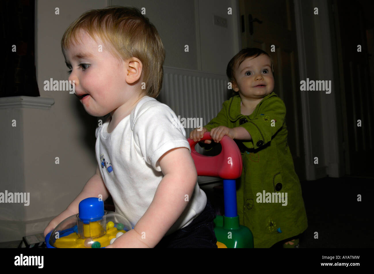 cousins boy girl toddlers one and two year old babies fun play together family Stock Photo - Alamy