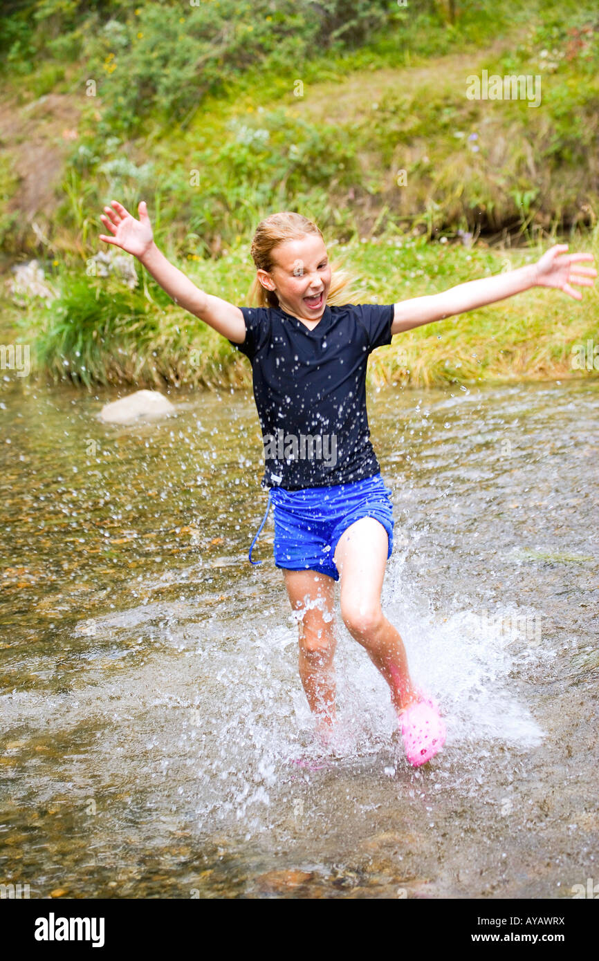 Girl running through water Stock Photo - Alamy