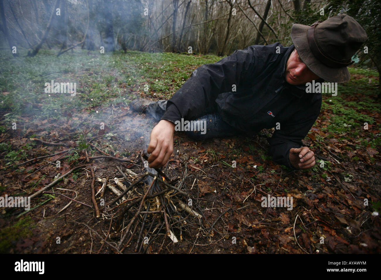 Man makes fire during bushcraft hi-res stock photography and images - Alamy
